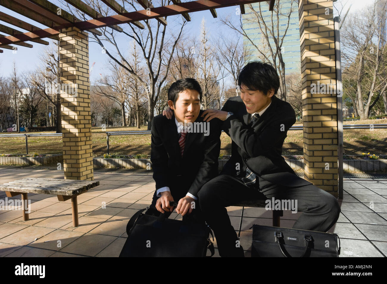 Businessman being consoled Stock Photo - Alamy