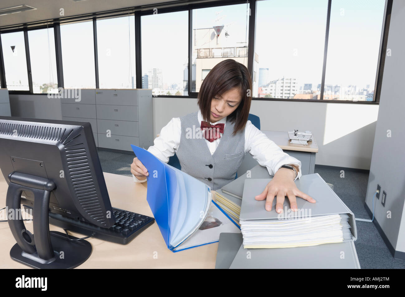 Office worker looking through file Stock Photo - Alamy