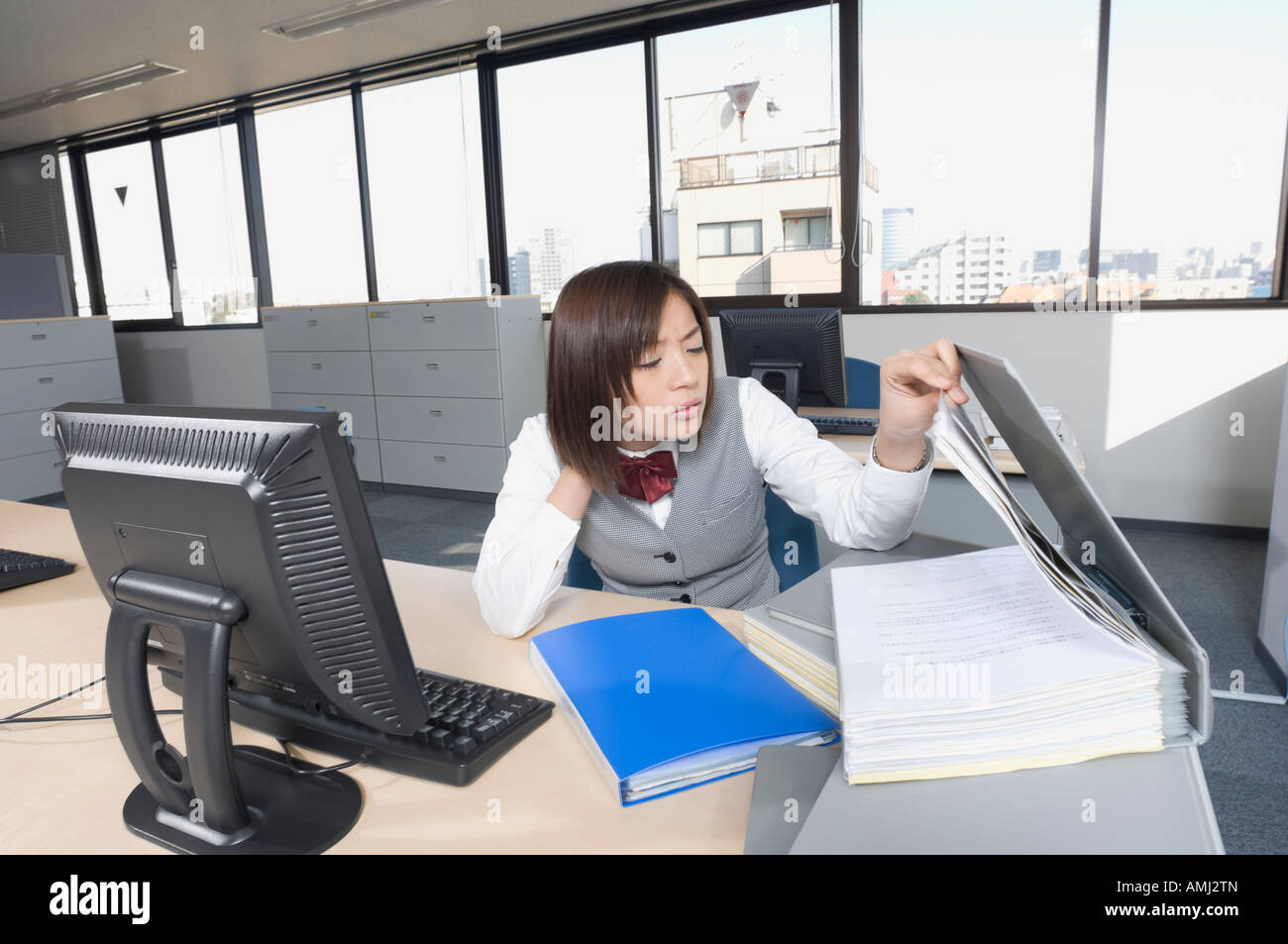 Office worker looking through file Stock Photo - Alamy