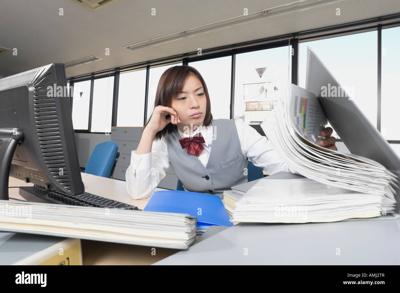 Office worker looking through file Stock Photo - Alamy