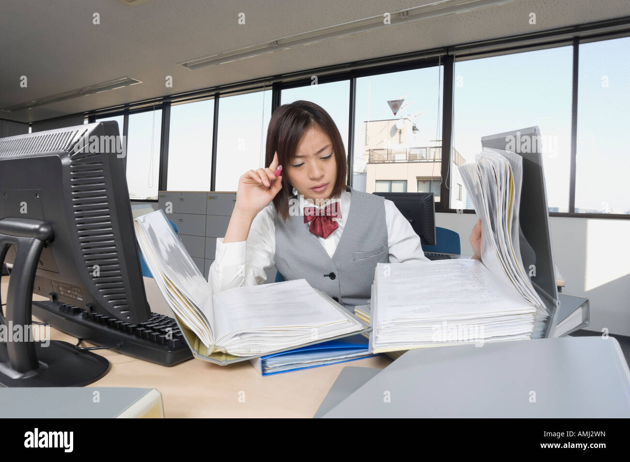 Office worker looking through files Stock Photo - Alamy