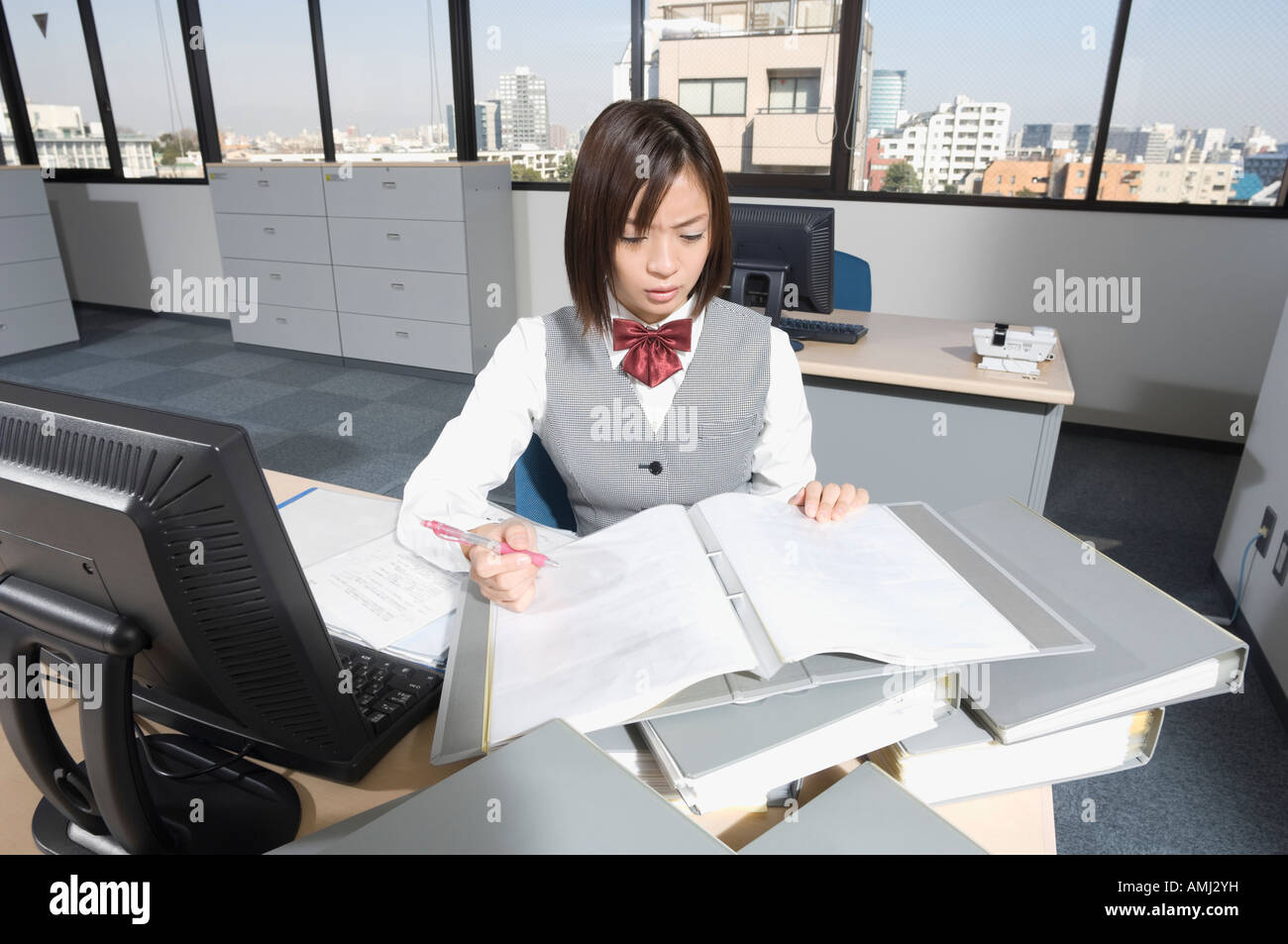 Office worker looking through file Stock Photo - Alamy