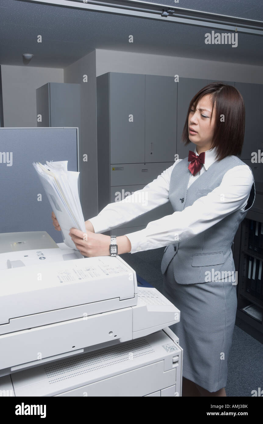 Office worker using photocopier Stock Photo - Alamy