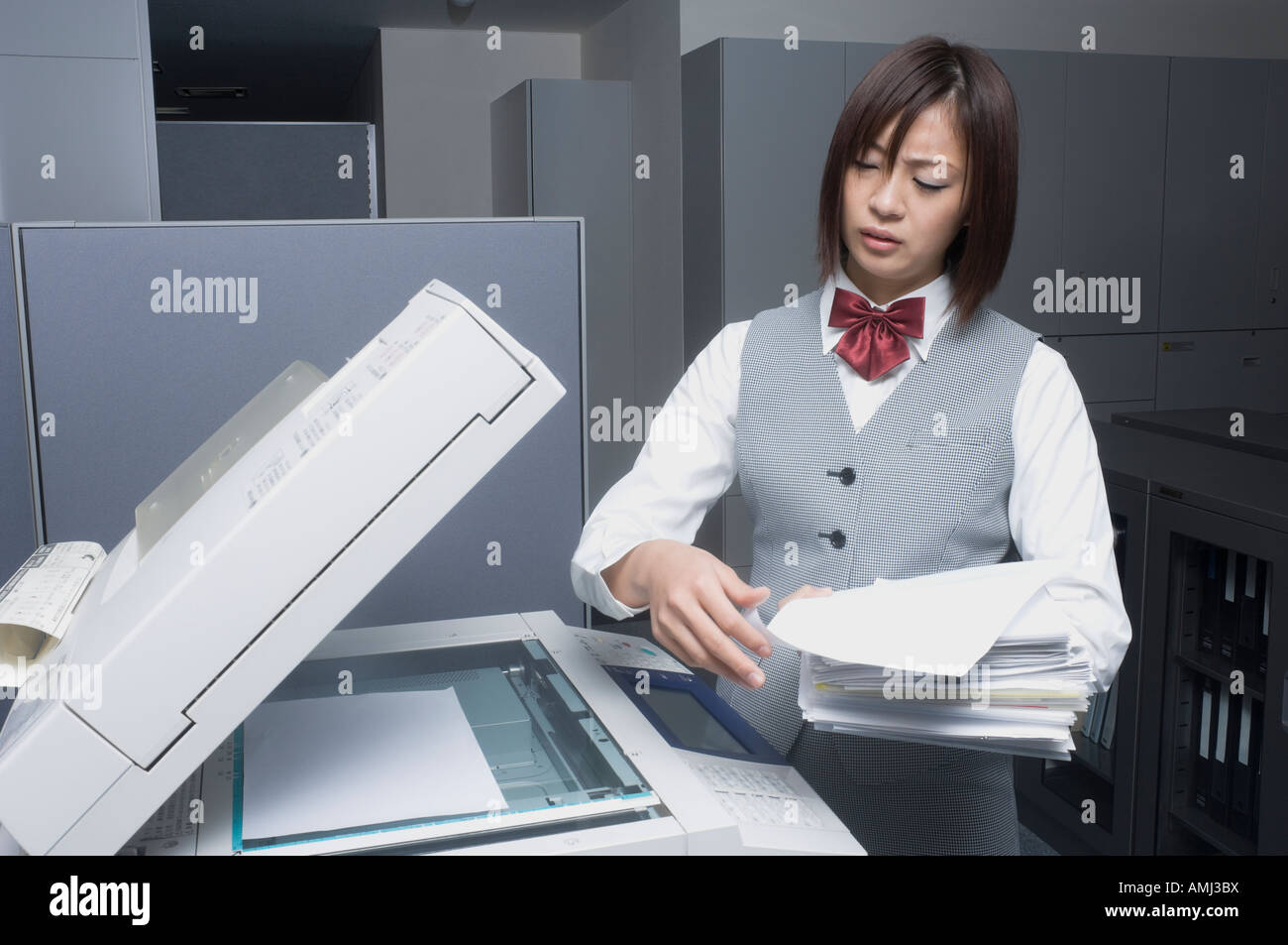 Office worker using photocopier Stock Photo - Alamy