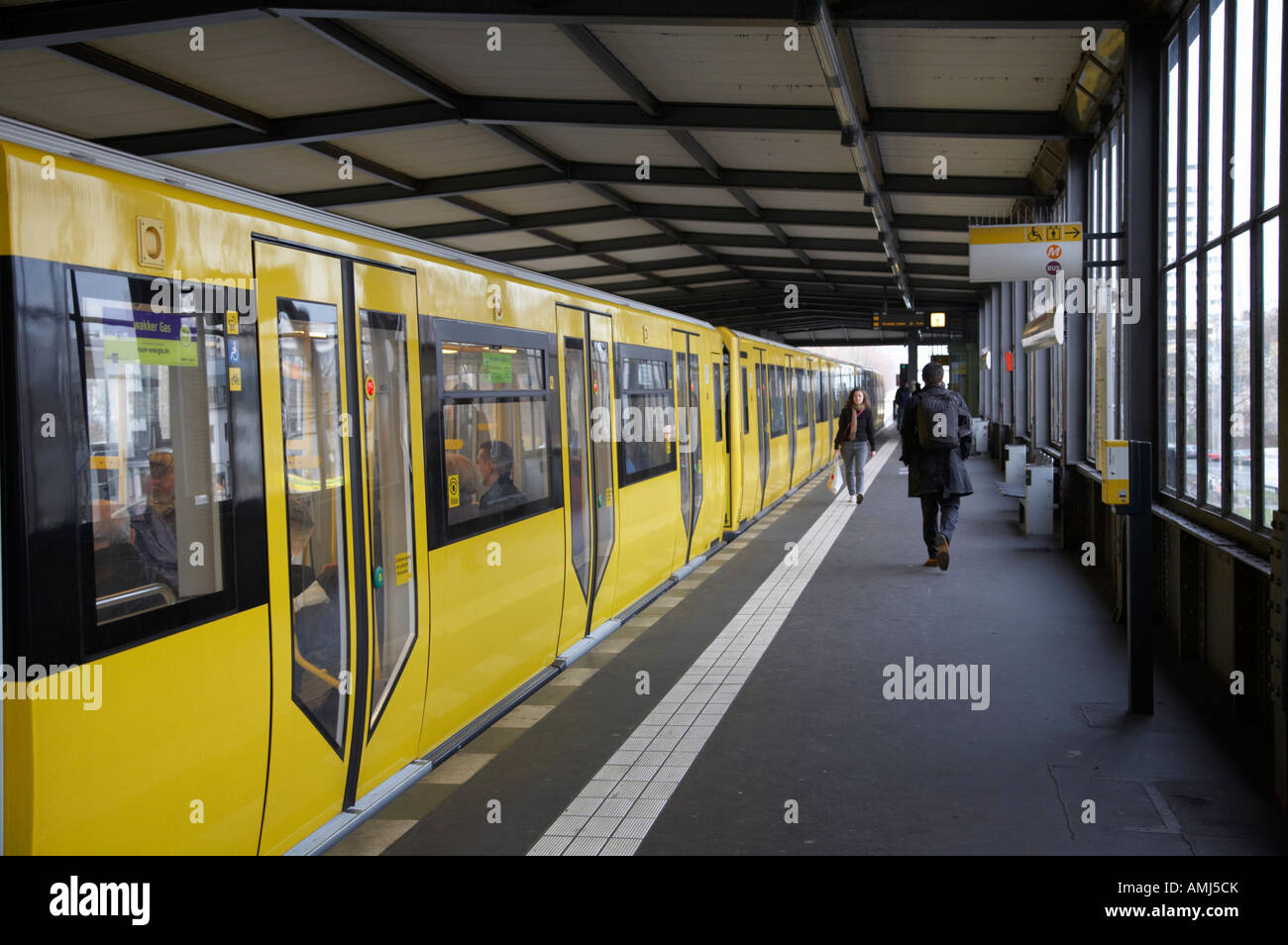 modern yellow u bahn train sitting at station platform Berlin Germany ...