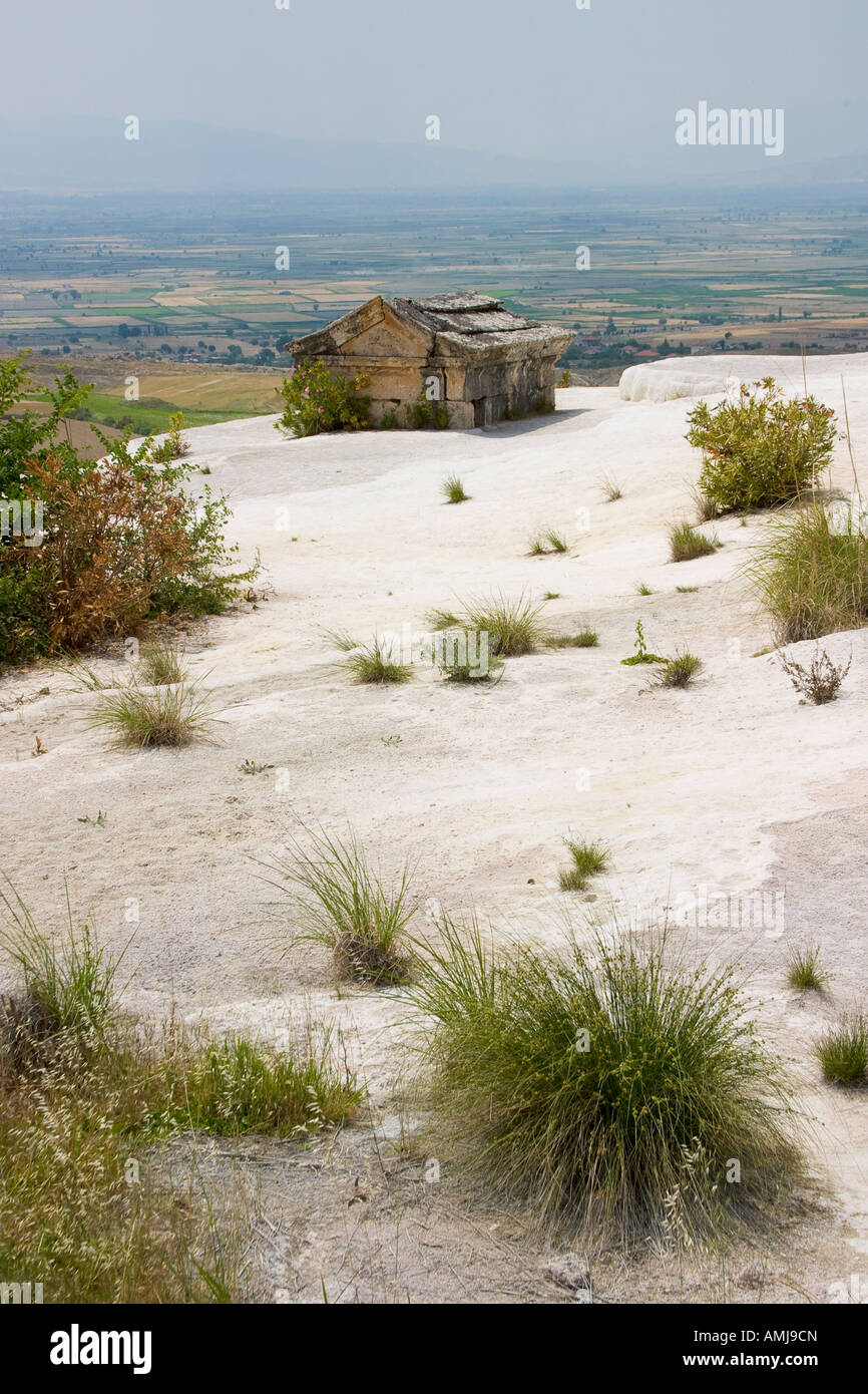 Sarcophagus embedded in white travertine rocks of Pamukkale ancient ...