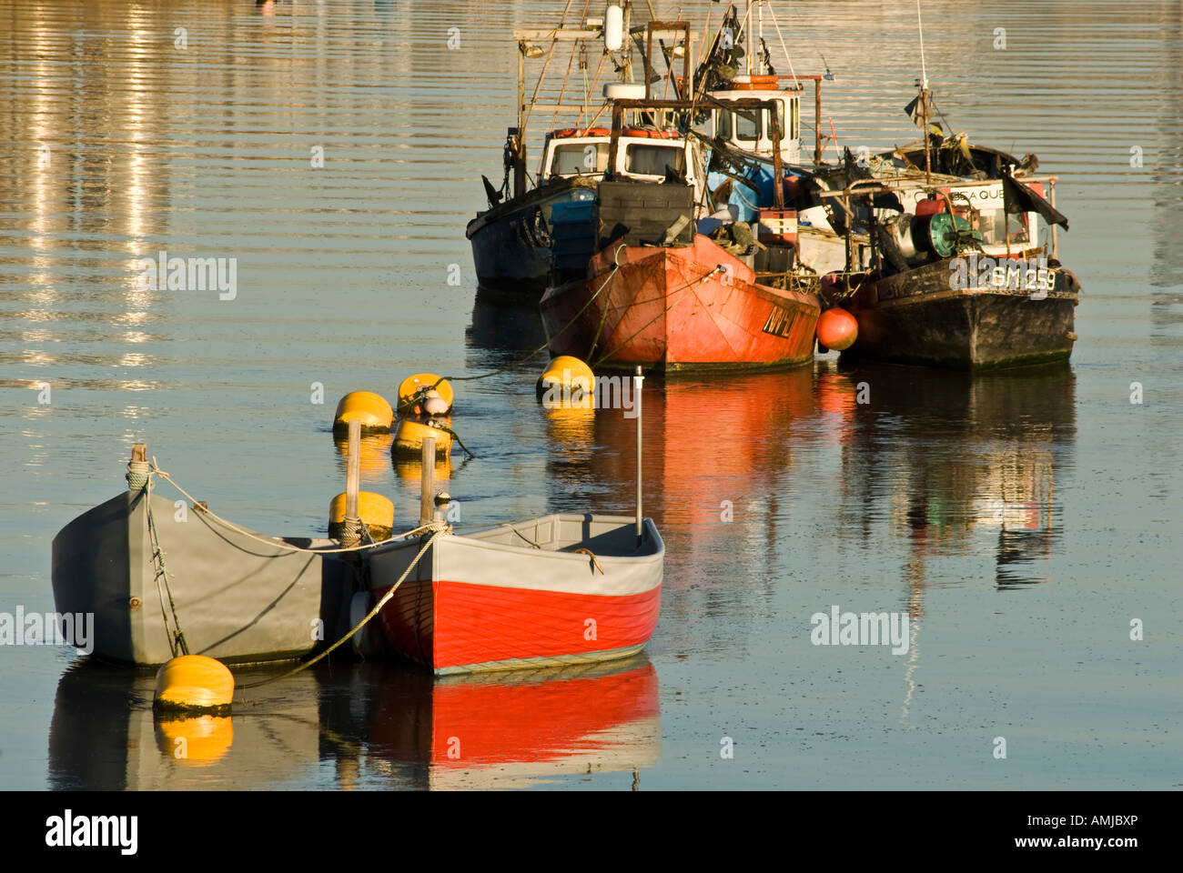 Tranquil scene Working boats Fishing trawlers Stock Photo - Alamy