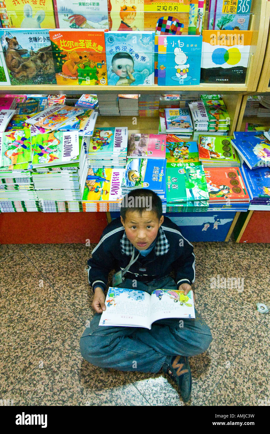Chinese Boy Reading a Book in a Bookstore Beijing China Stock Photo - Alamy