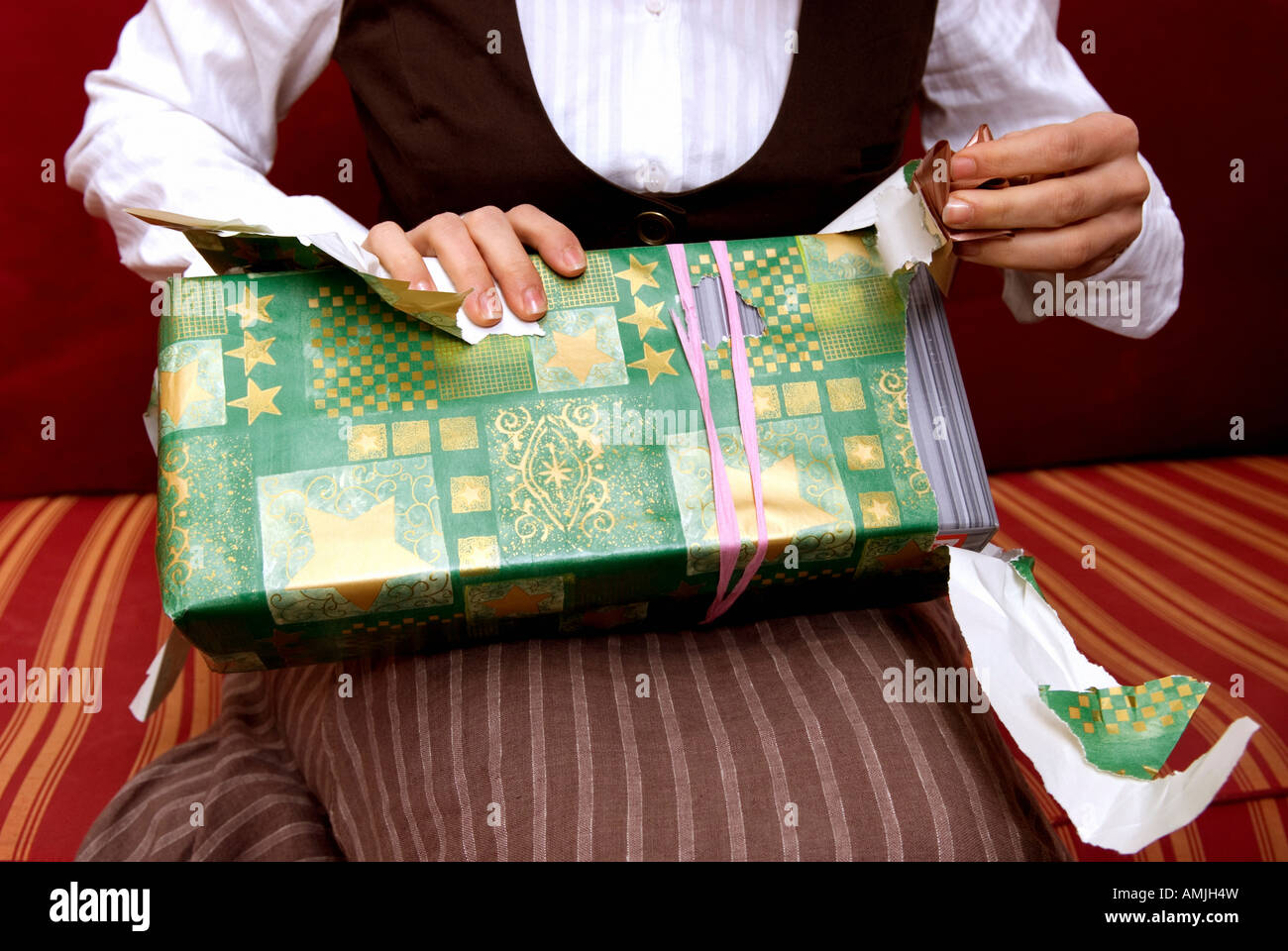 Woman opening a Christmas present Stock Photo - Alamy