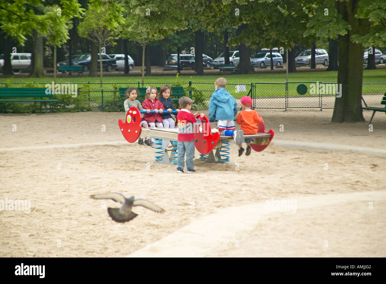 Children playing on ride in park Paris France Stock Photo - Alamy
