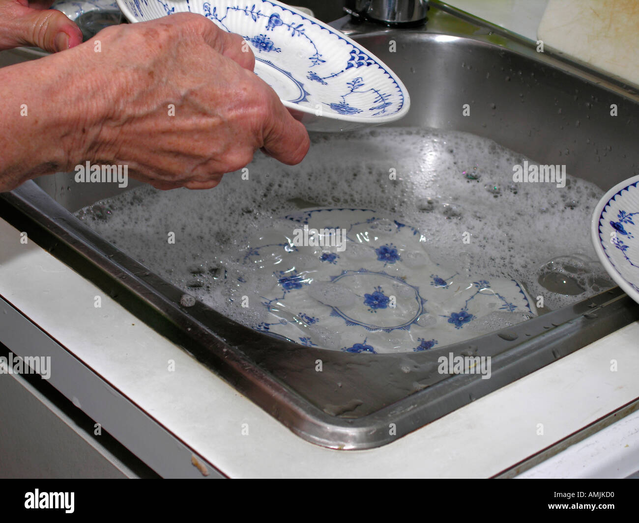 MR PR hands of an old woman washing the dishes Stock Photo - Alamy