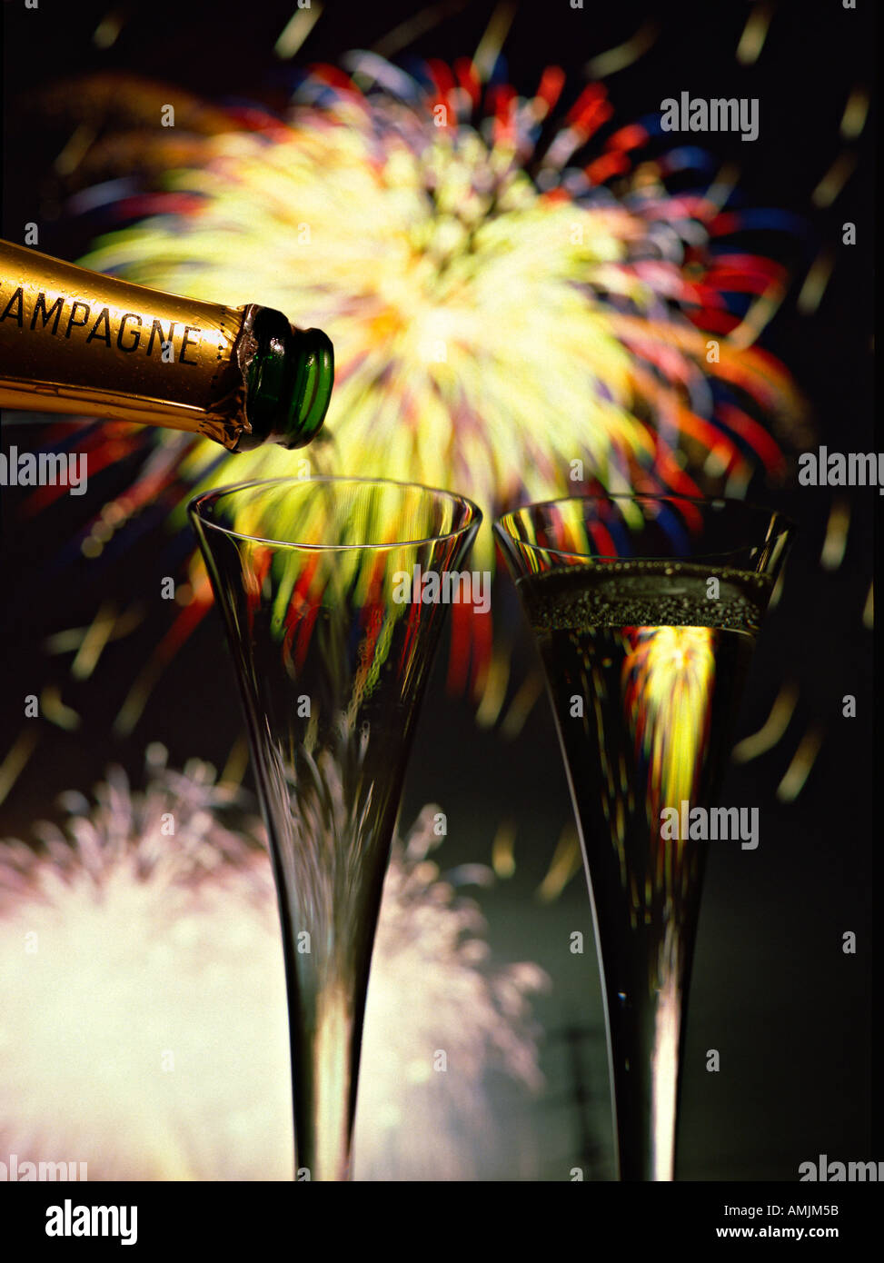 bottle of Champagne with glasses and fireworks Stock Photo - Alamy
