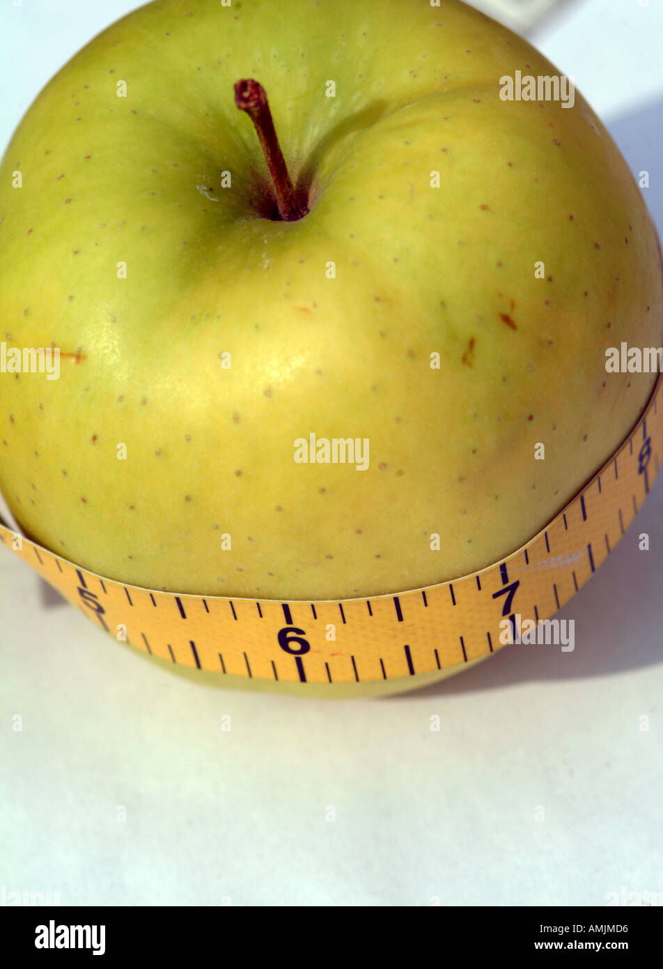 apple with tape measure around it Stock Photo - Alamy