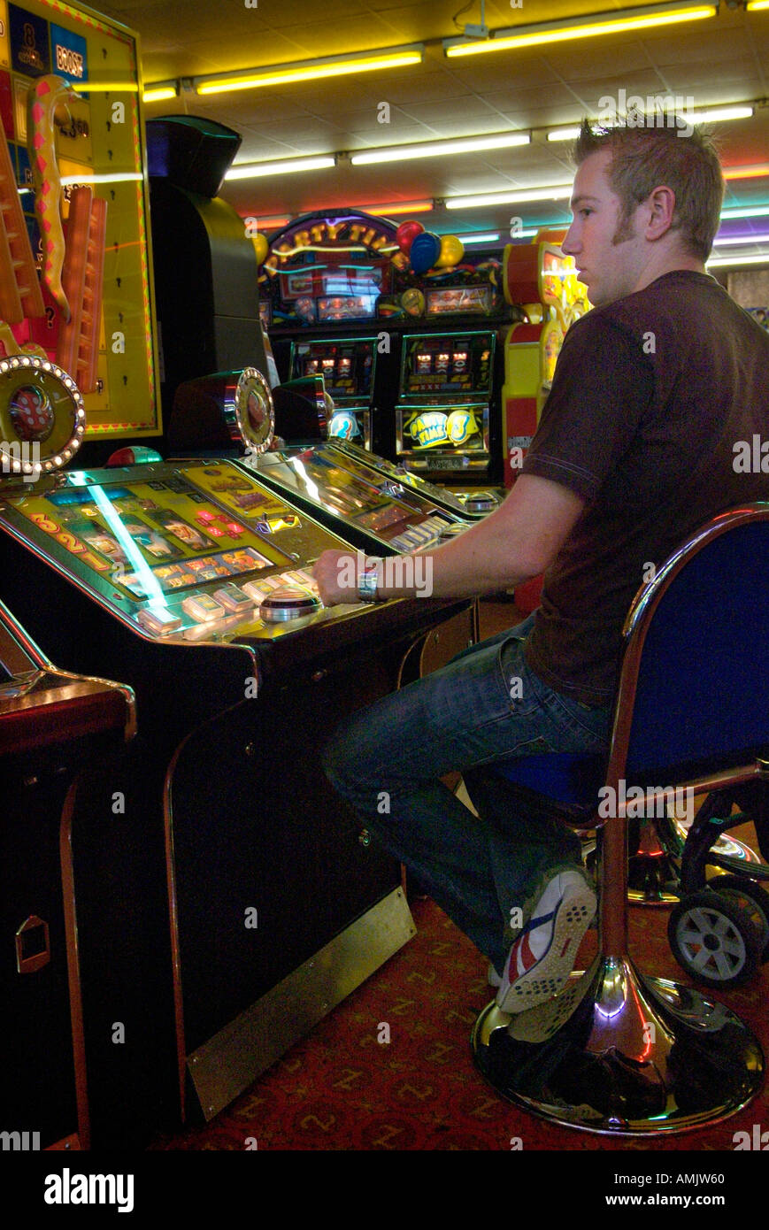 Amusement arcade sea slot machine gamble man England UK United Kingdom ...