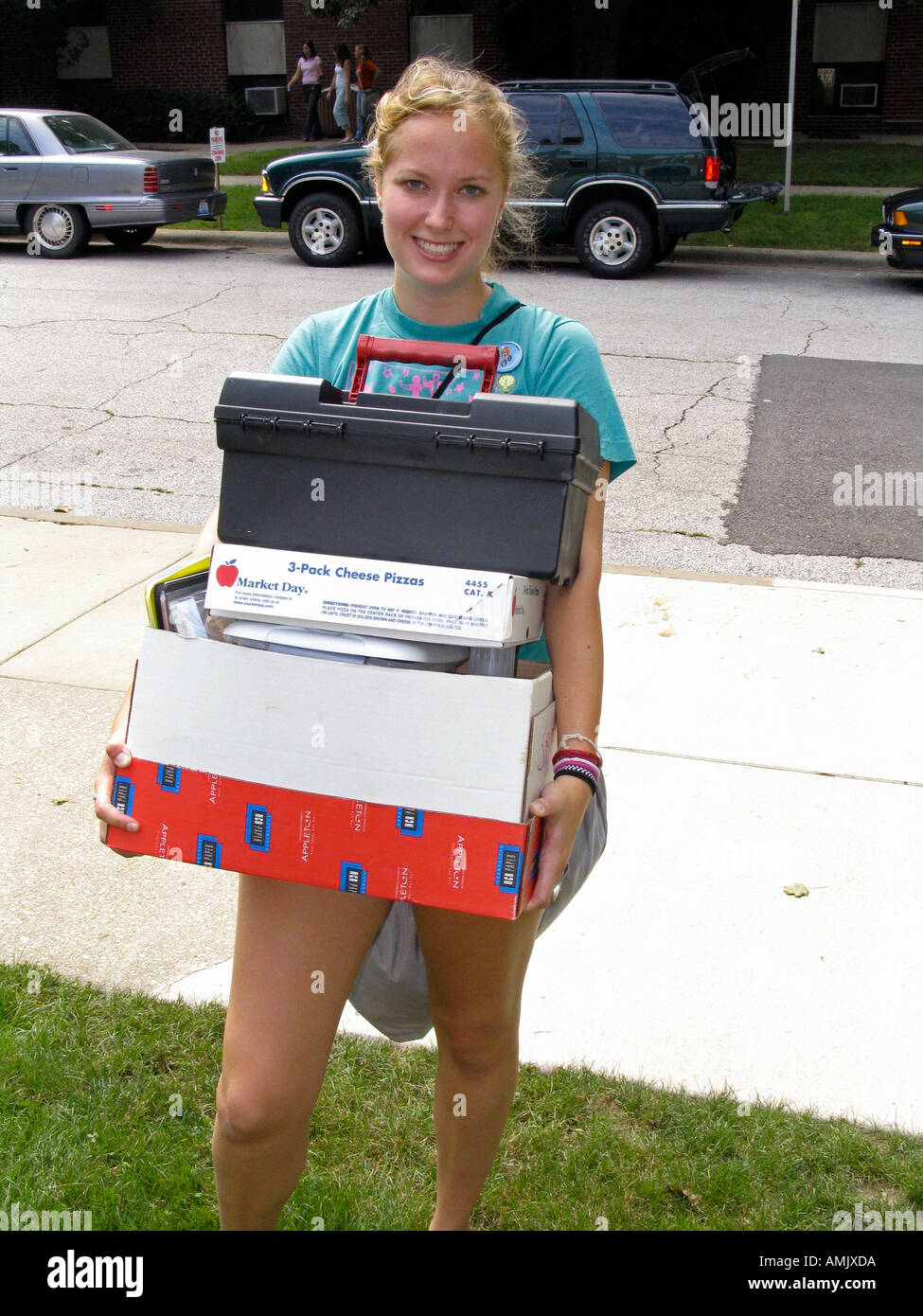 University student with tool box and supplies moving in to halls of ...