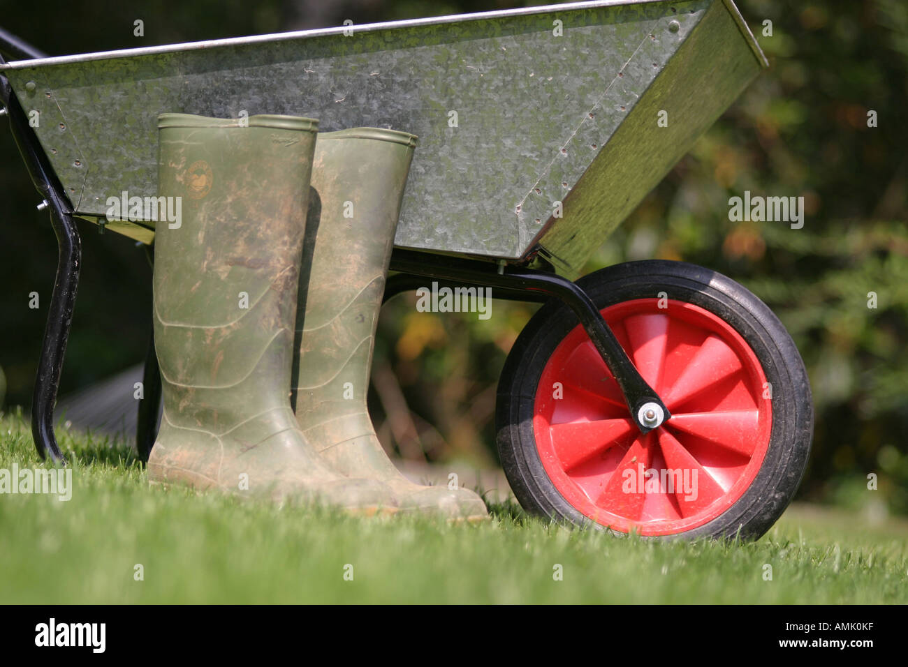 a stock photograph of a wheelbarrow and wellington boots Stock Photo ...