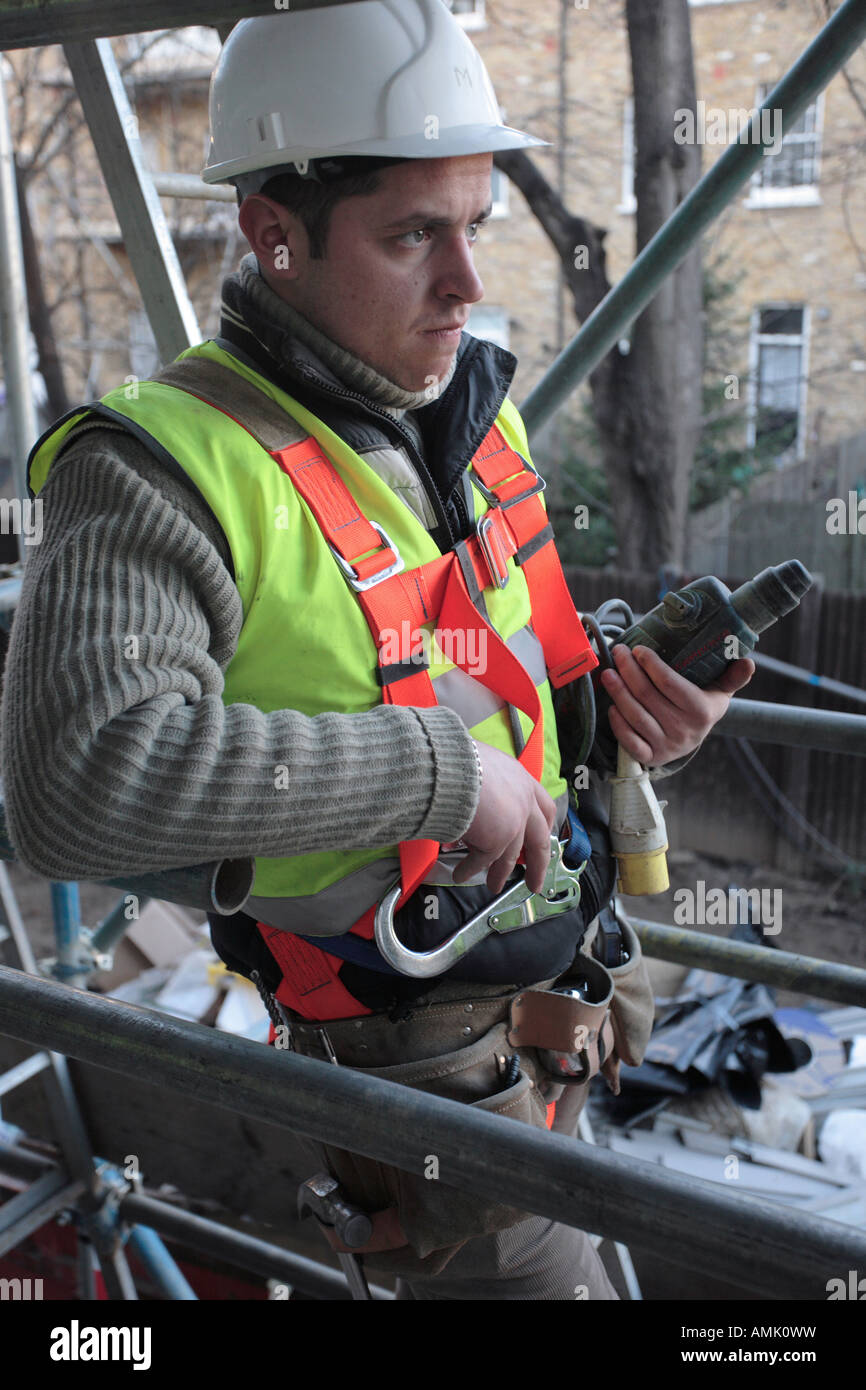 Lithuanian construction worker standing on scaffolding at a building ...