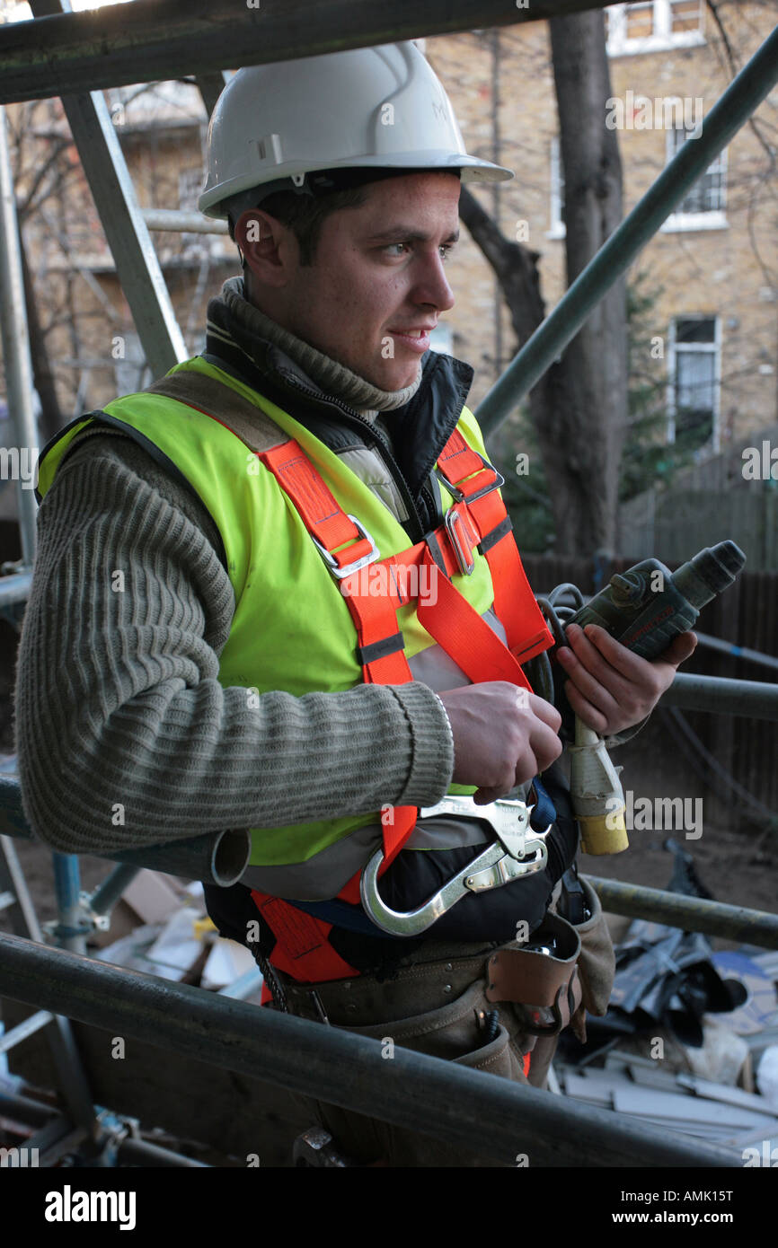 Lithuanian construction worker standing on scaffolding at a building ...