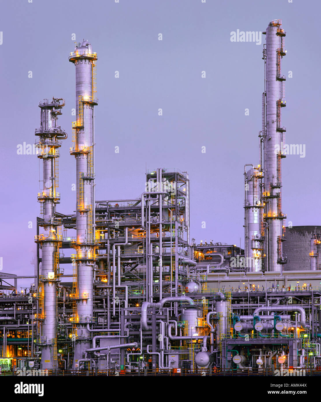 A small section of convoluted pipe work against a purple twilit sky at ...