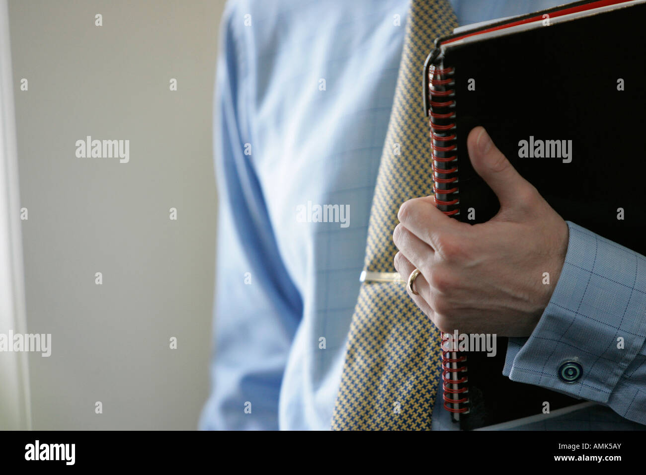 CLOSE-UP OF A MALE OFFICE WORKER HOLDING A FILE Stock Photo - Alamy