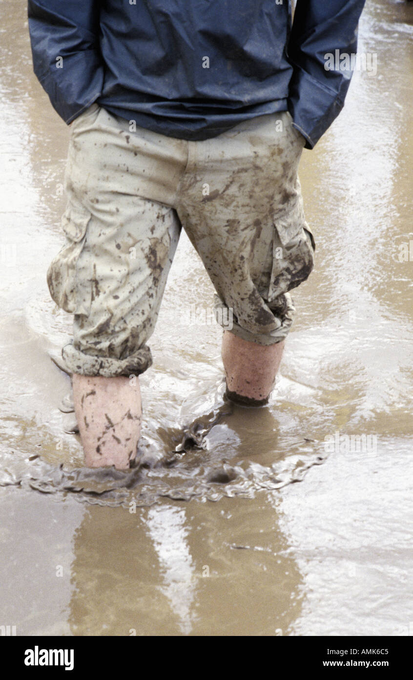 man walking through mud at the Glastonbury festival Stock Photo - Alamy