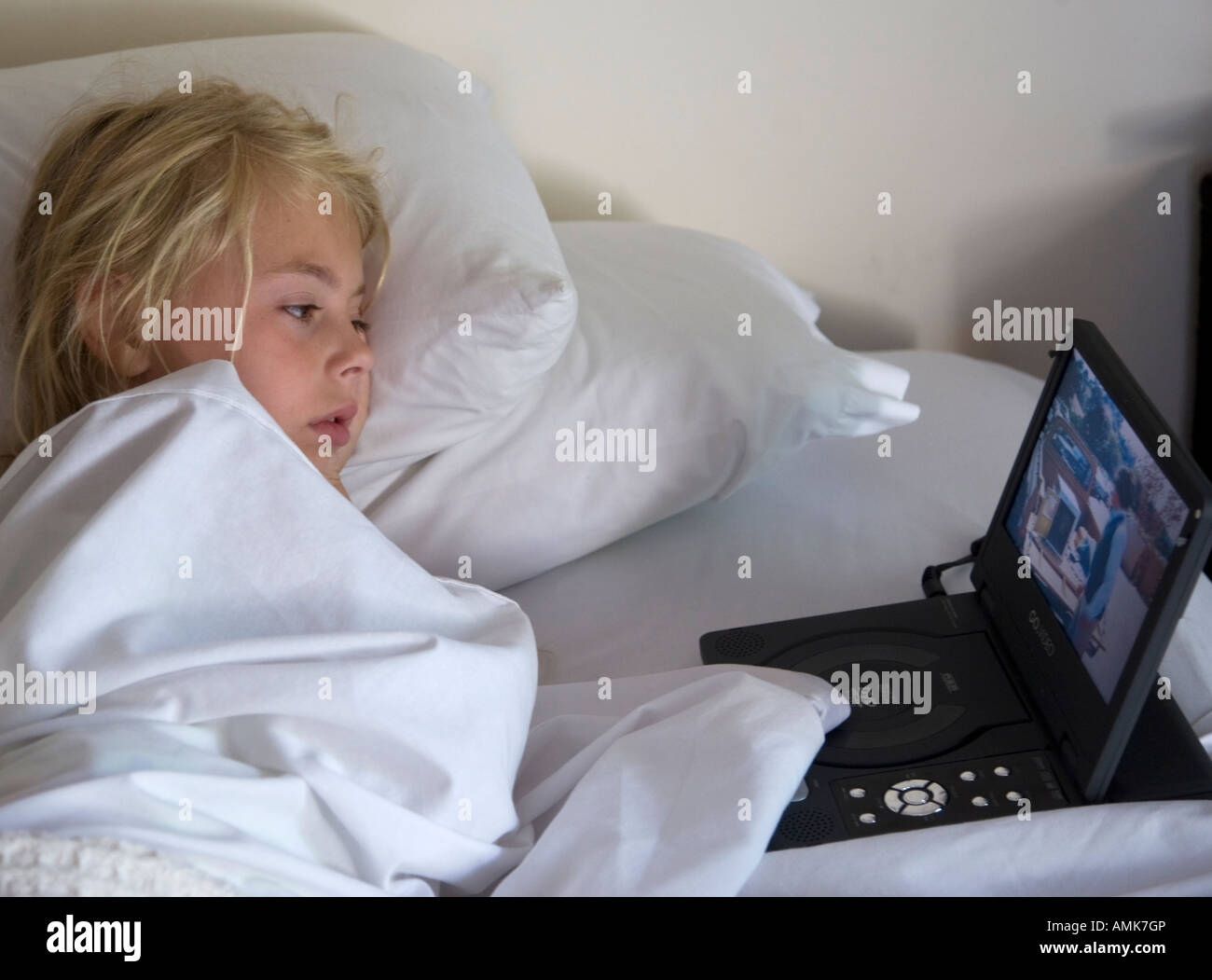 Young girl watching a video on a portable DVD player Stock Photo - Alamy