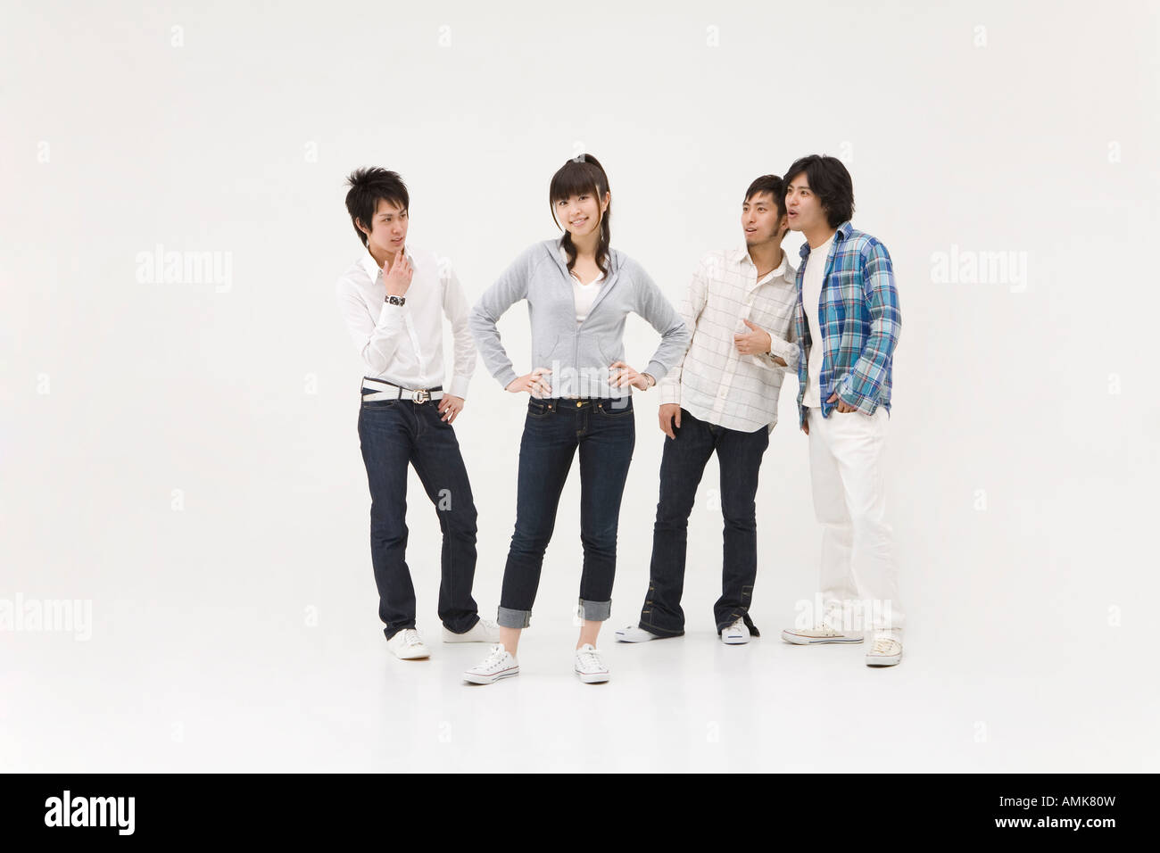 A young woman standing with arms akimbo Stock Photo - Alamy