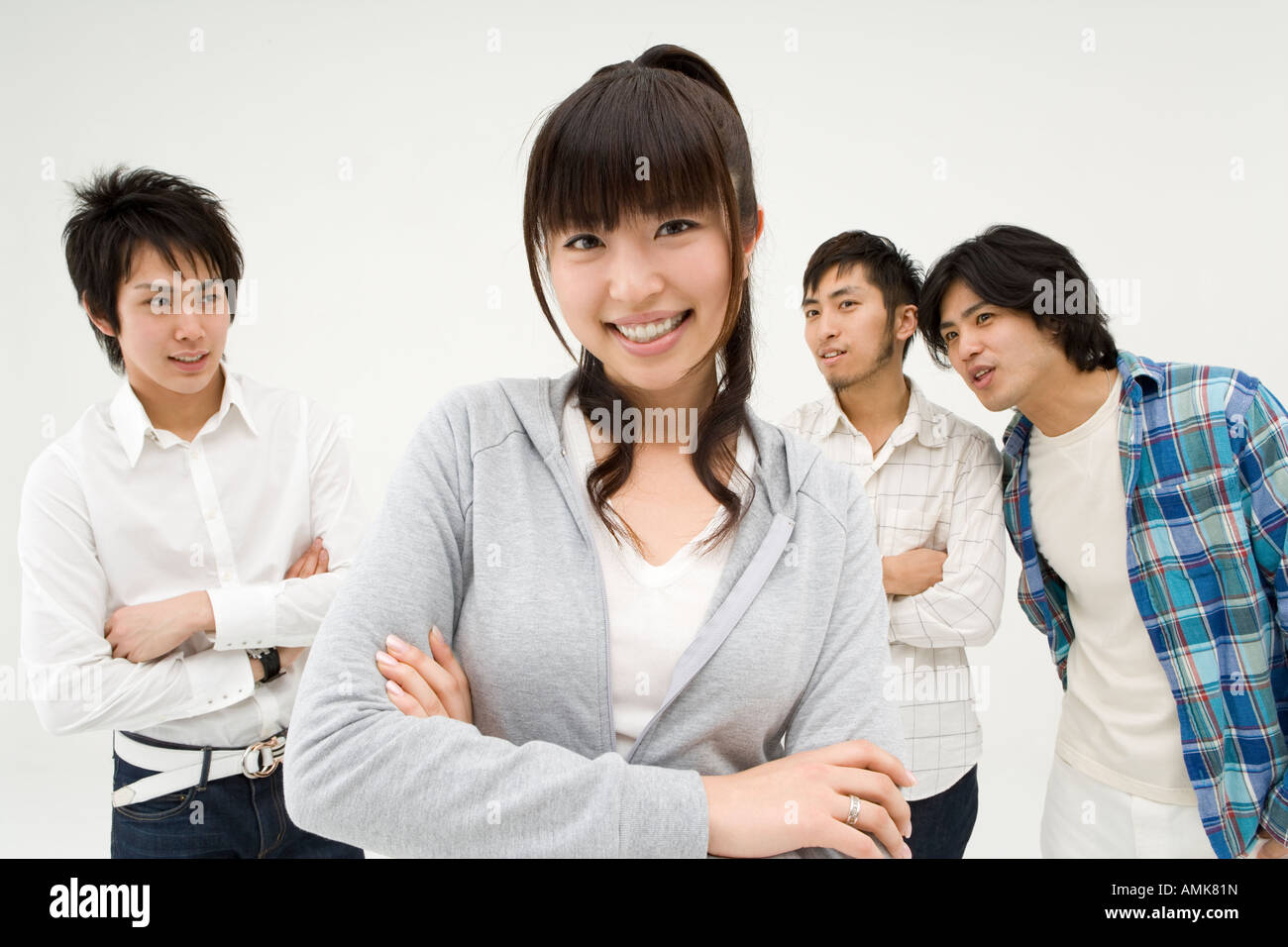 A young woman standing with arm crossed Stock Photo - Alamy