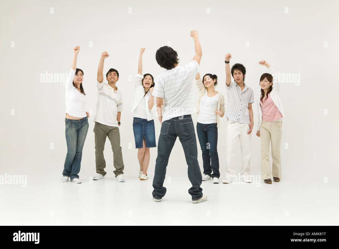 Young people raising hands Stock Photo - Alamy