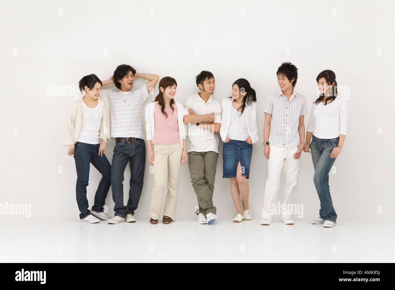 Young people standing in a line Stock Photo - Alamy