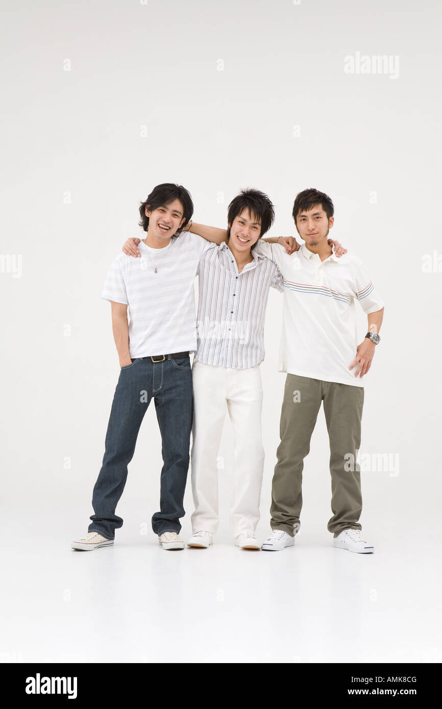 Three young men standing with arms around Stock Photo - Alamy
