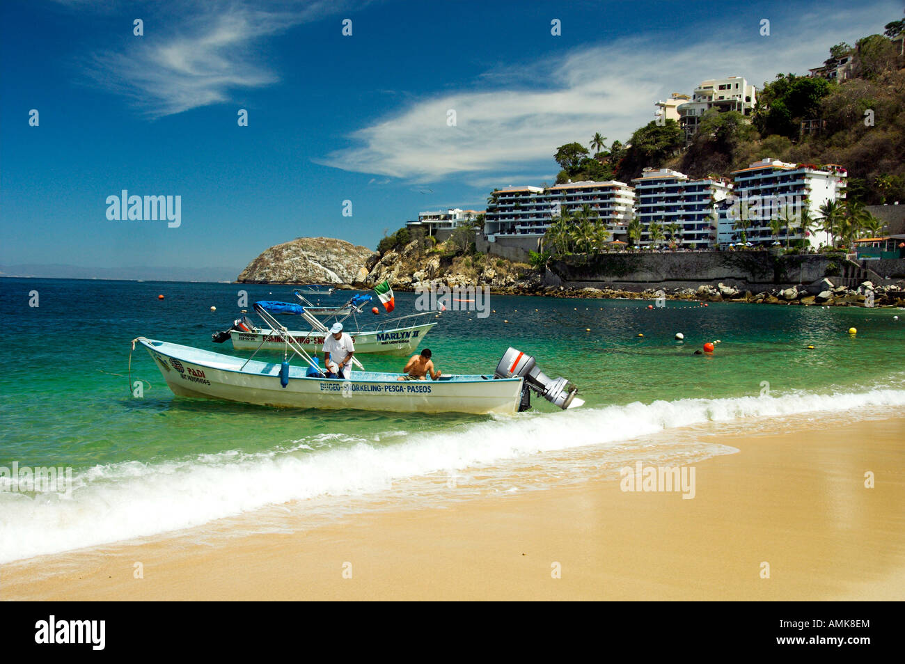 Mismaloya Beach with colorful boats and thatched shelters south of ...