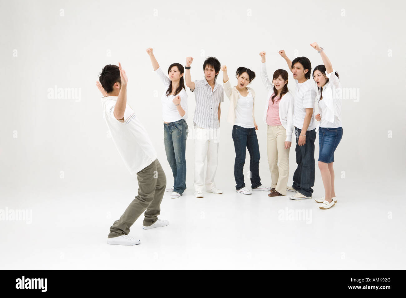 Group of people shouting at young man Stock Photo - Alamy