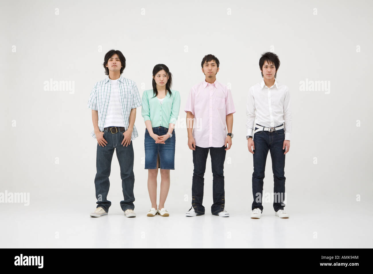 Young woman standing among three men Stock Photo - Alamy