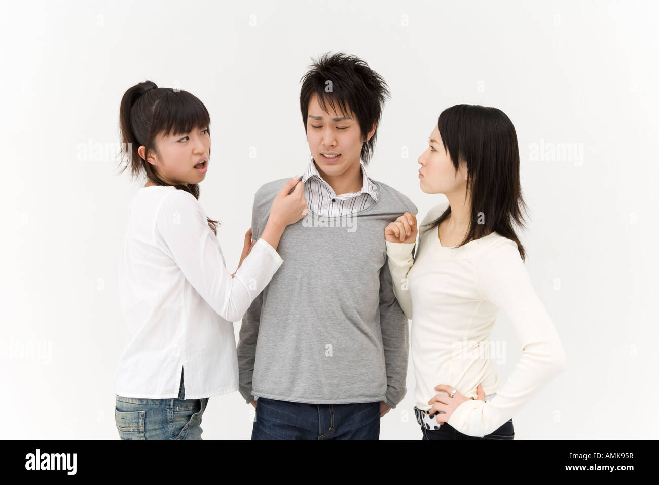Young man accused by two young women Stock Photo - Alamy