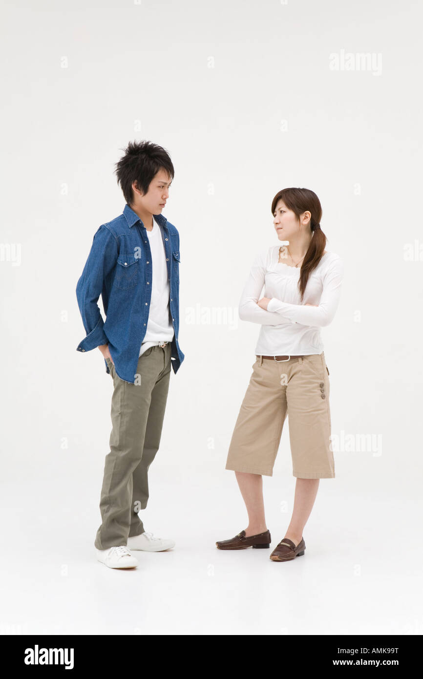 Young couple glaring at each other Stock Photo - Alamy