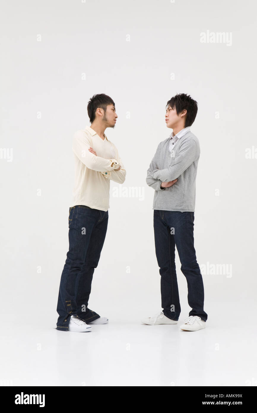 Two young men glaring at each other Stock Photo - Alamy