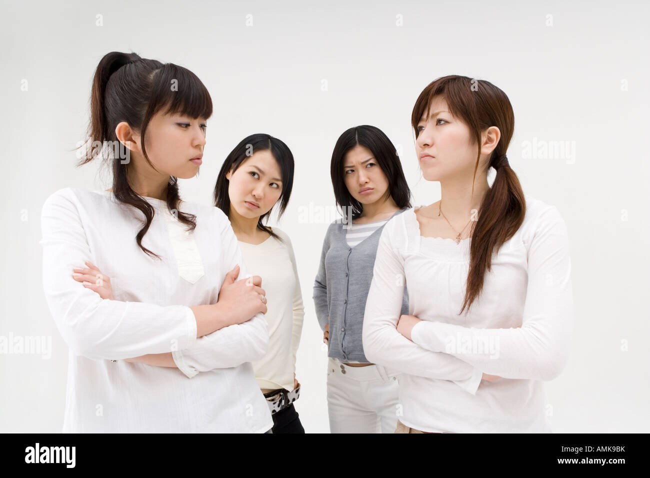 Four young women glaring at each other Stock Photo - Alamy