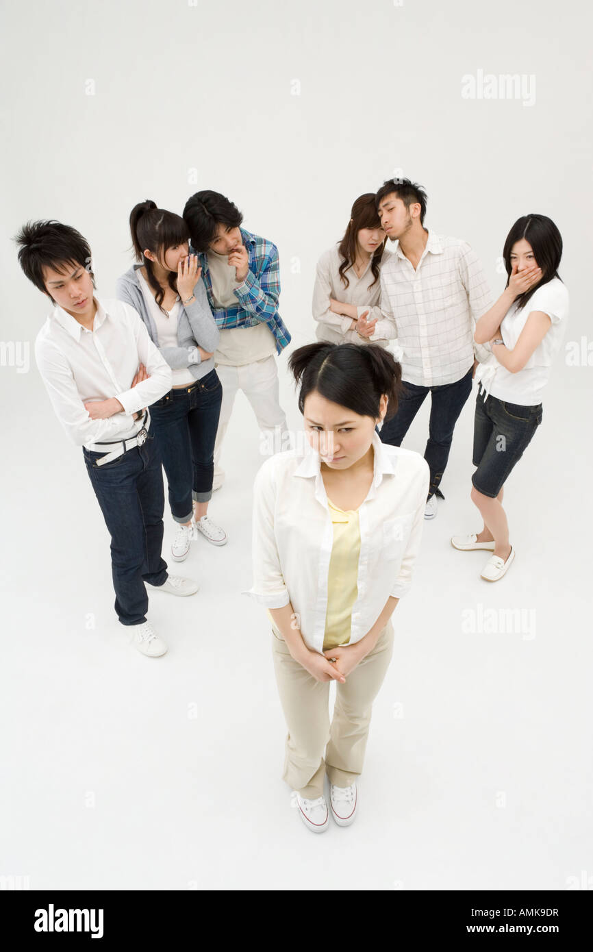 Young woman excluded from group of people Stock Photo - Alamy