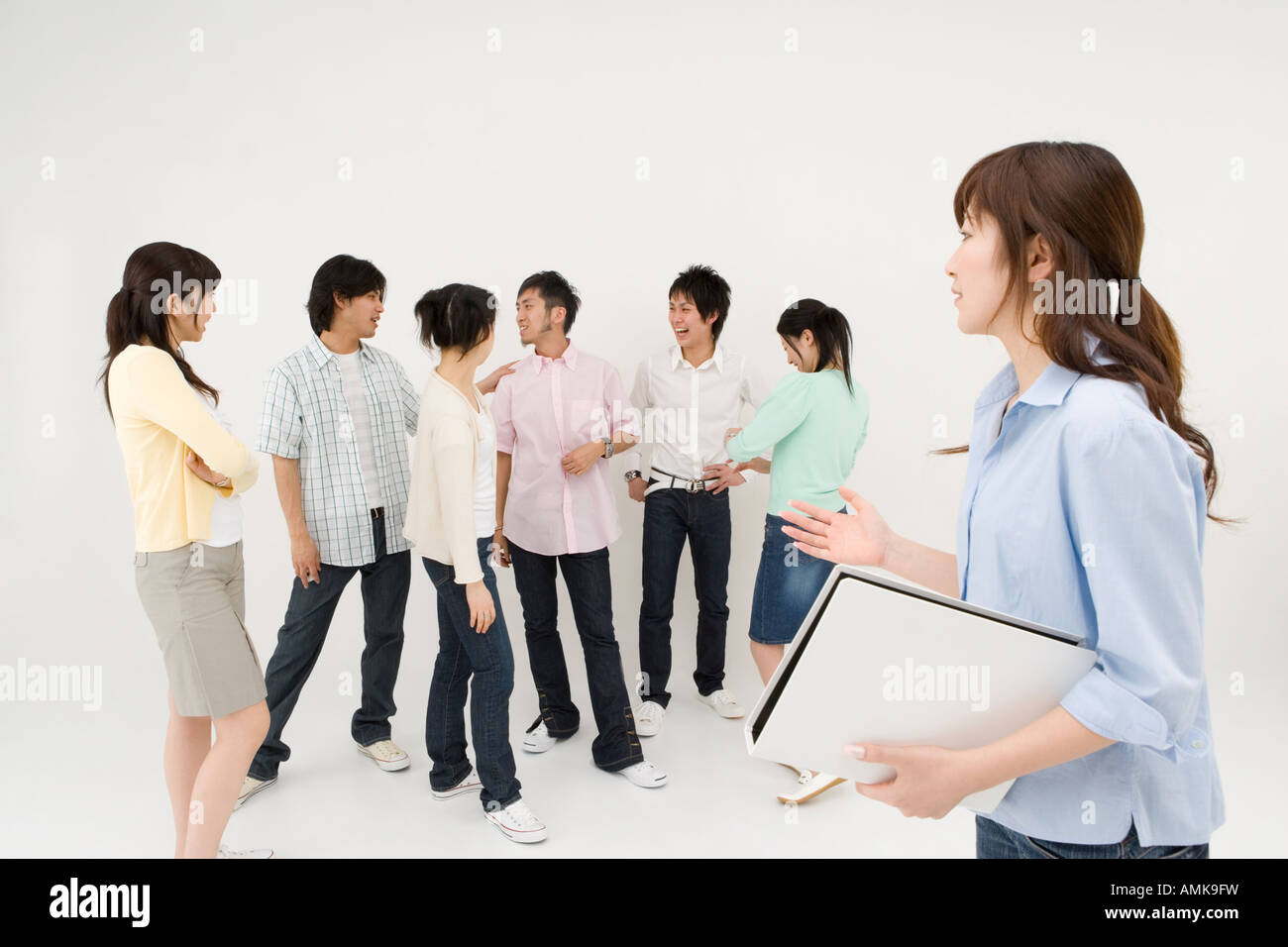 Young woman excluded from group of people Stock Photo - Alamy