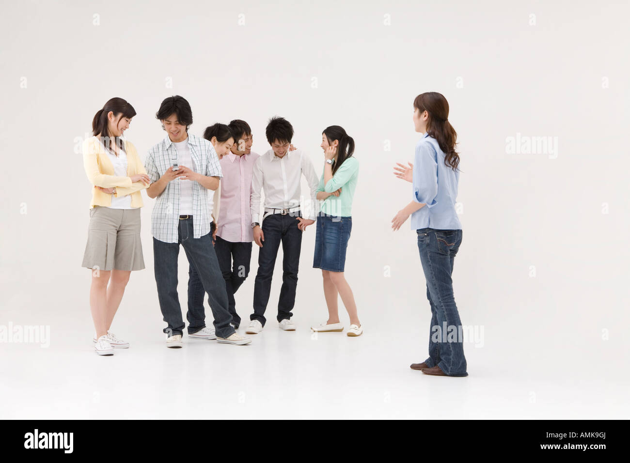 Young woman excluded from group of people Stock Photo - Alamy