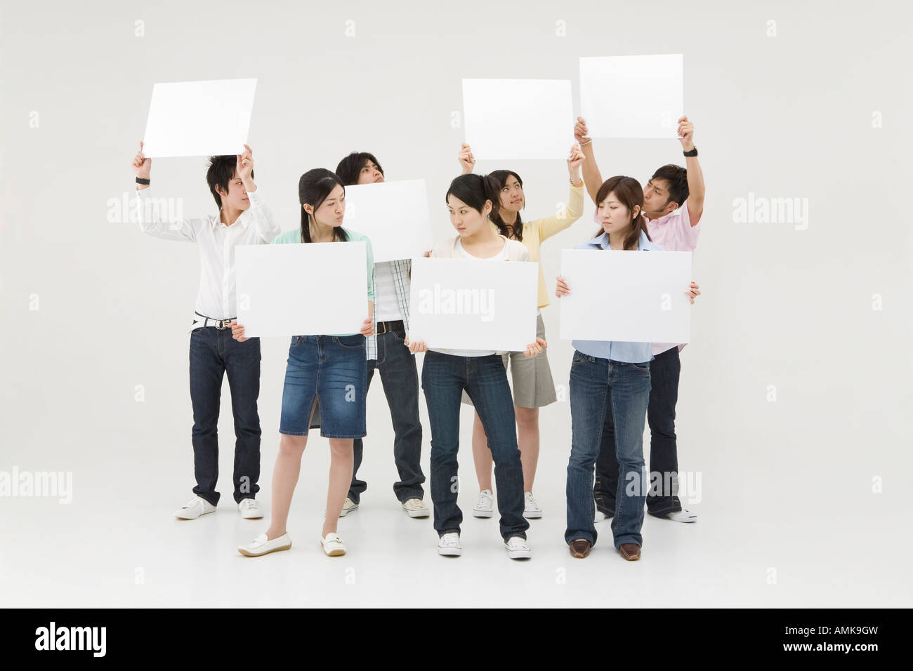 Group of people holding blank message board Stock Photo - Alamy