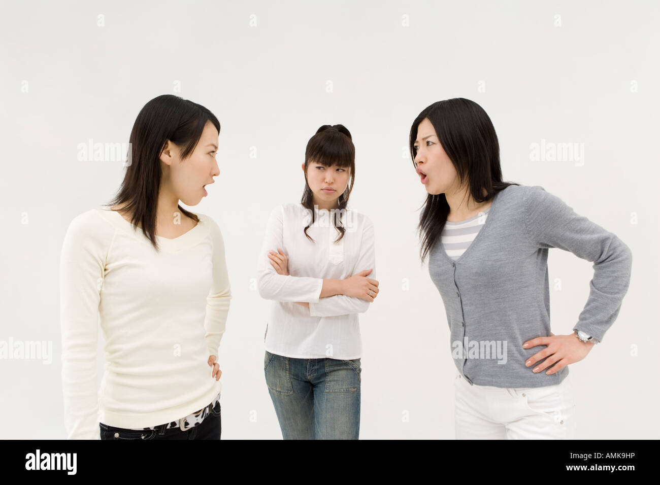 Three young women arguing Stock Photo - Alamy