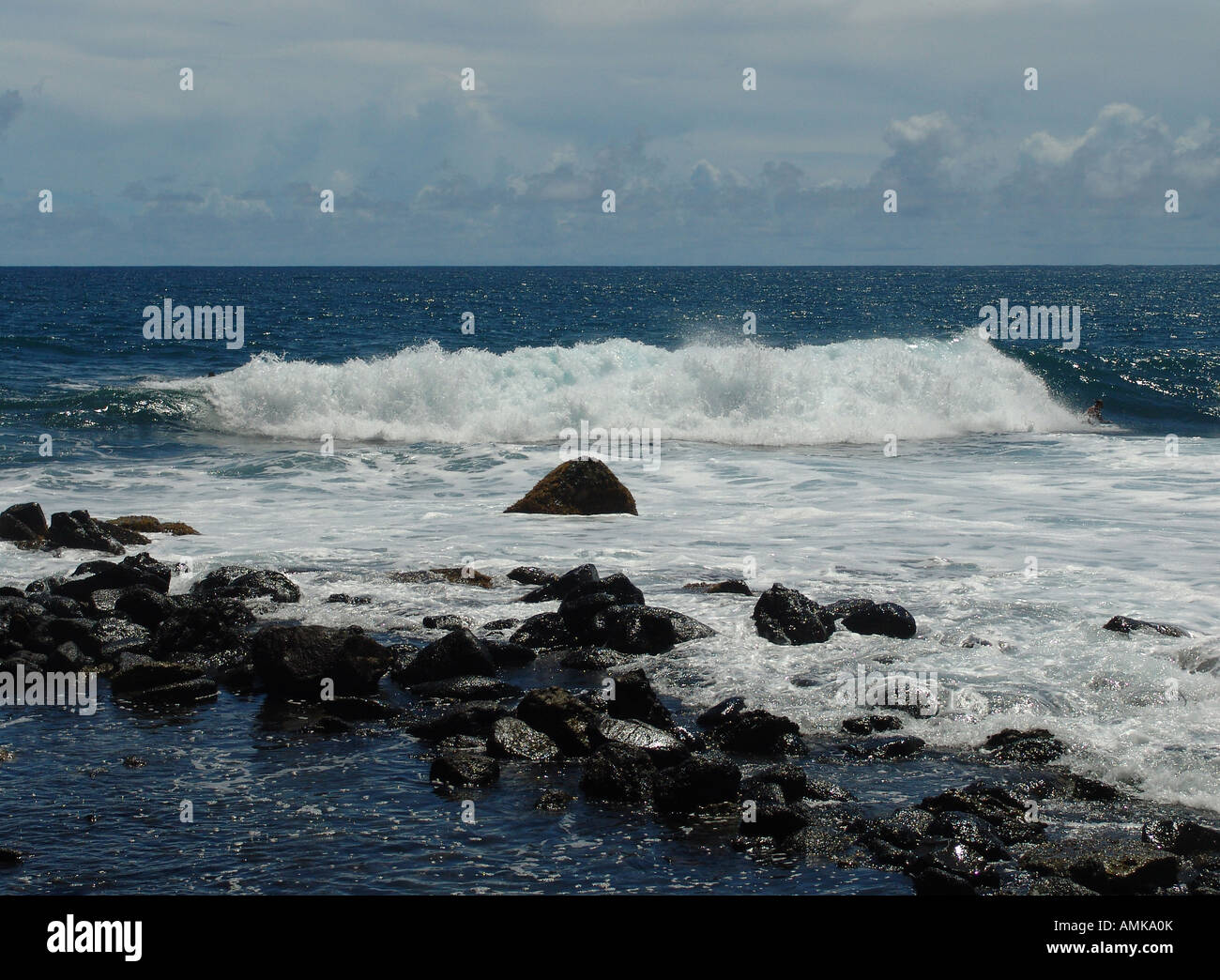 Ocean waves on the rocky beach in Tahiti Stock Photo - Alamy