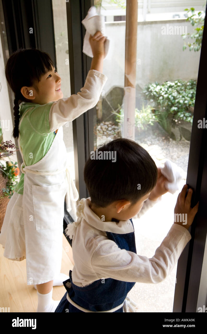 Children cleaning window Stock Photo - Alamy
