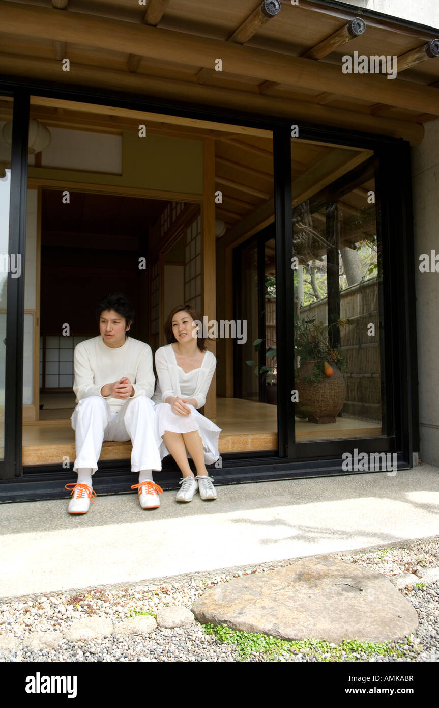 Couple sitting on veranda Stock Photo - Alamy