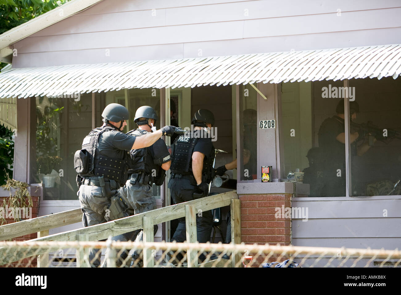 Police officers from tactical narcotics unit carrying out high risk ...
