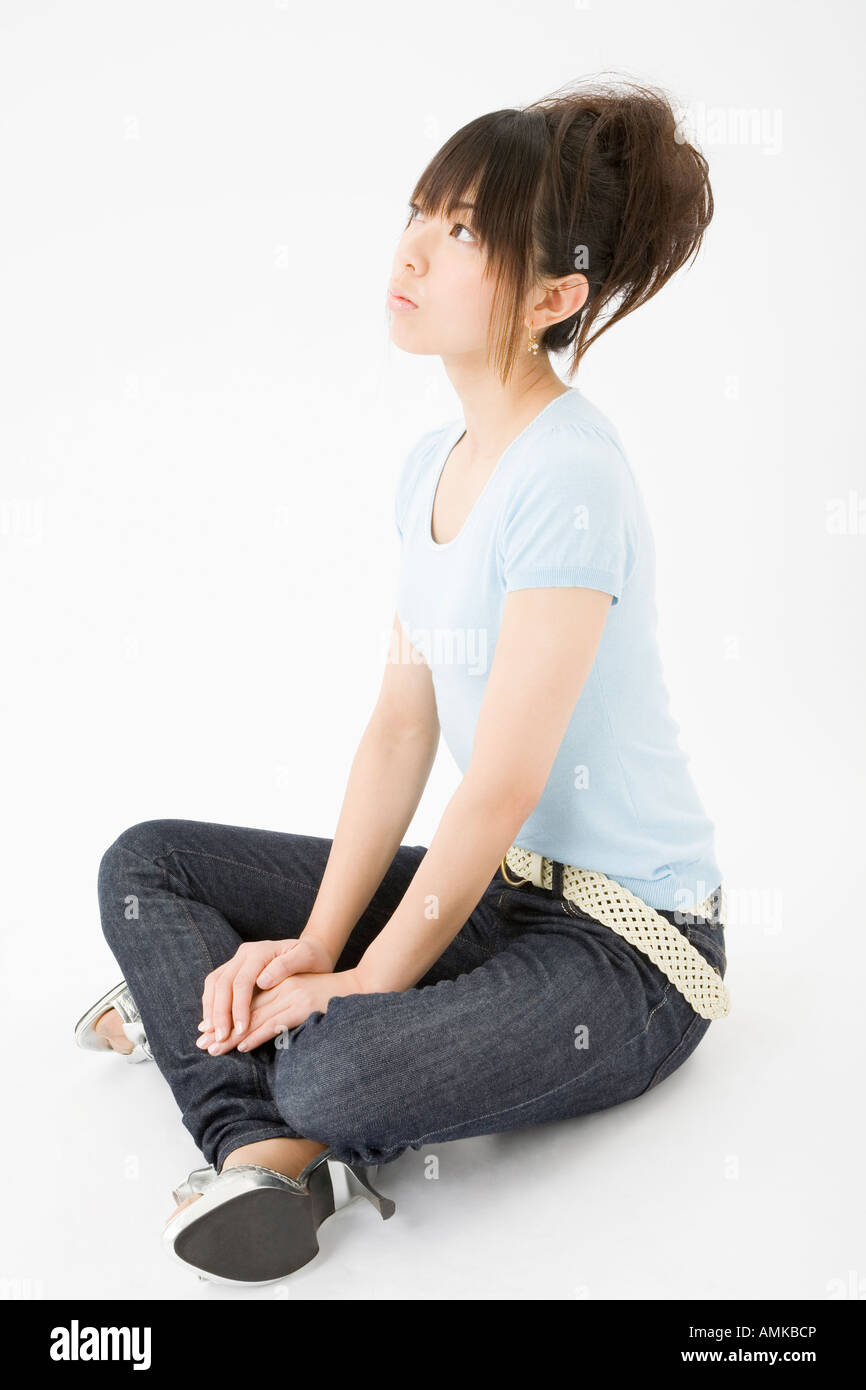Young woman sitting Stock Photo - Alamy