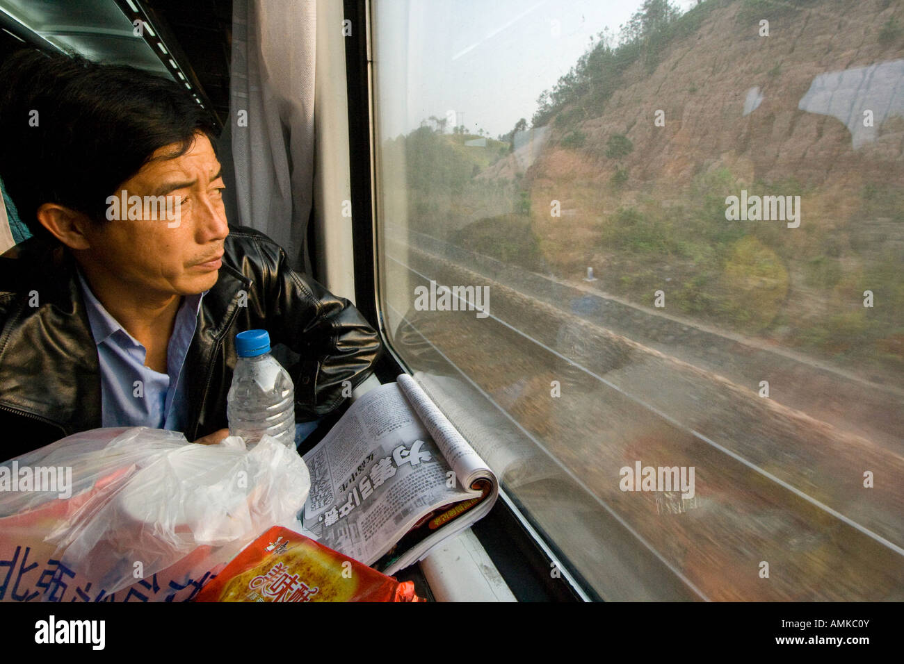 Chinese Man Riding Train in China Looking out Winow Stock Photo - Alamy