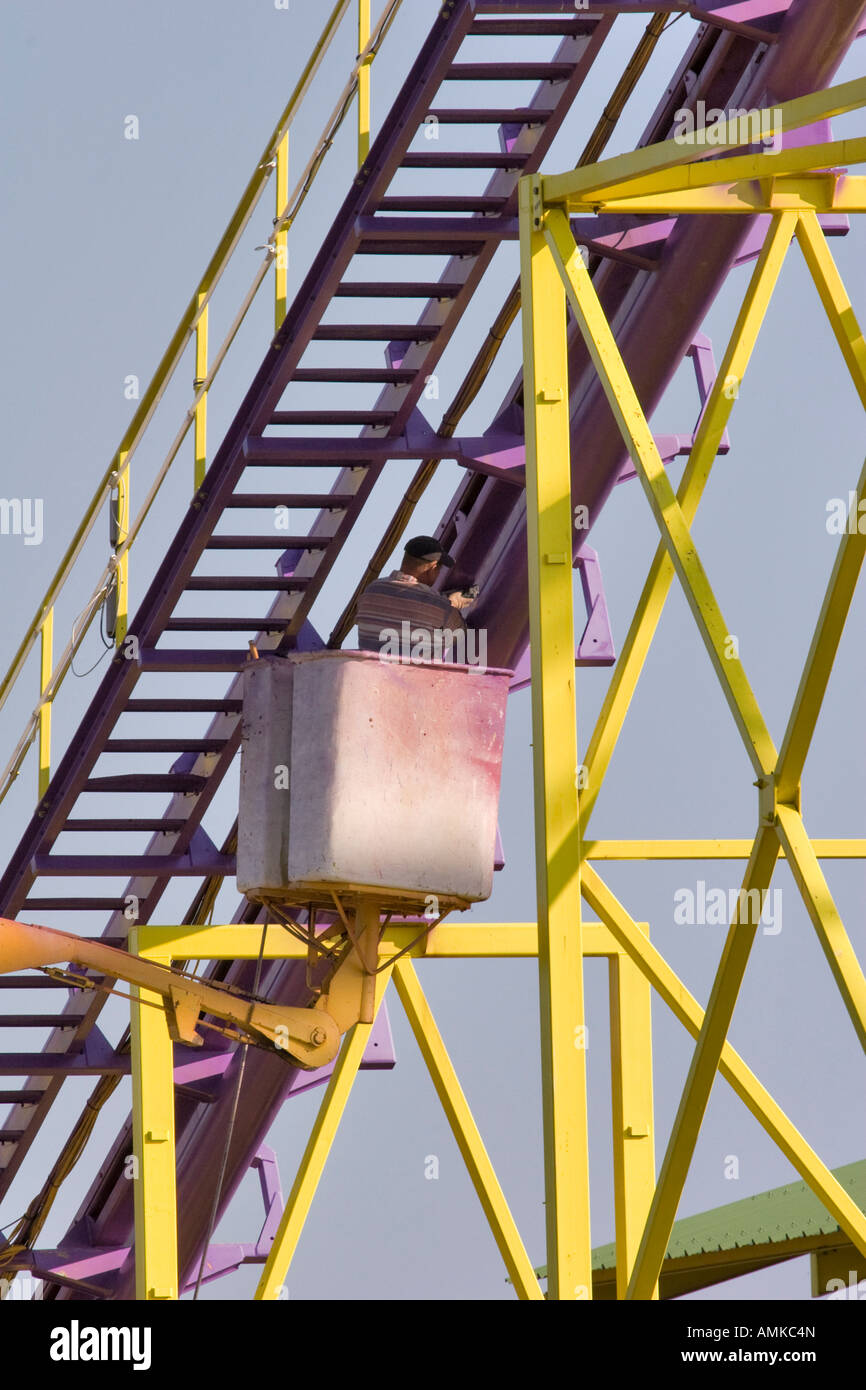 Worker painting the roller coaster Stock Photo - Alamy